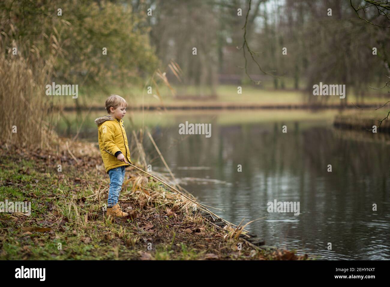Kid child fishing with stick hi-res stock photography and images - Alamy