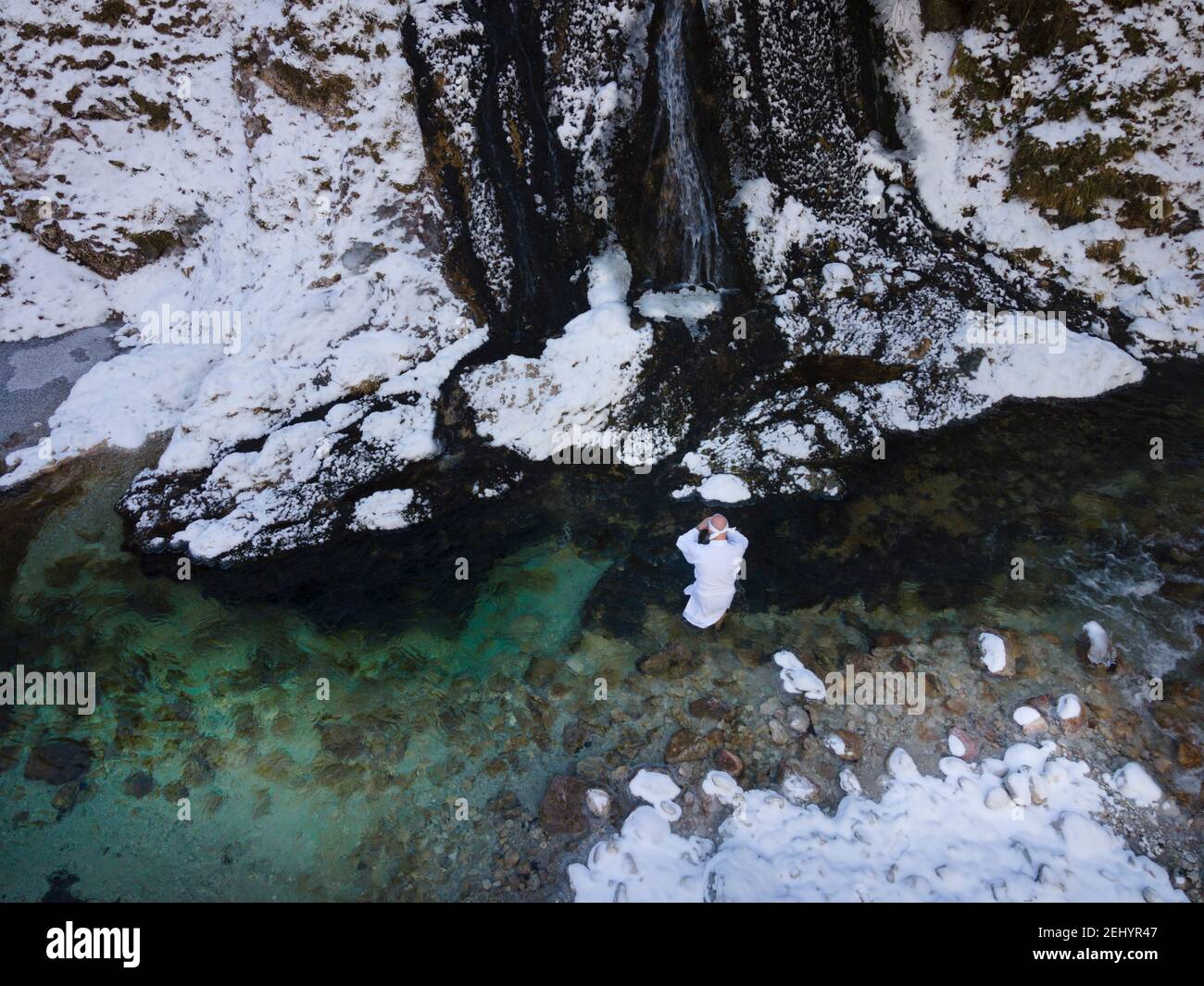 European man in traditional Japanese Shugendo outfit meditates in front ...