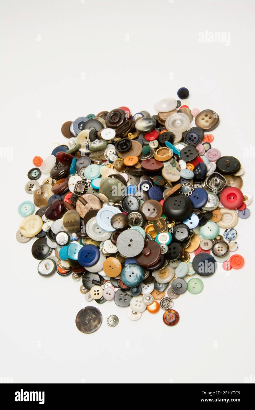 Collection of assorted buttons in various colors and sizes scattered on ...