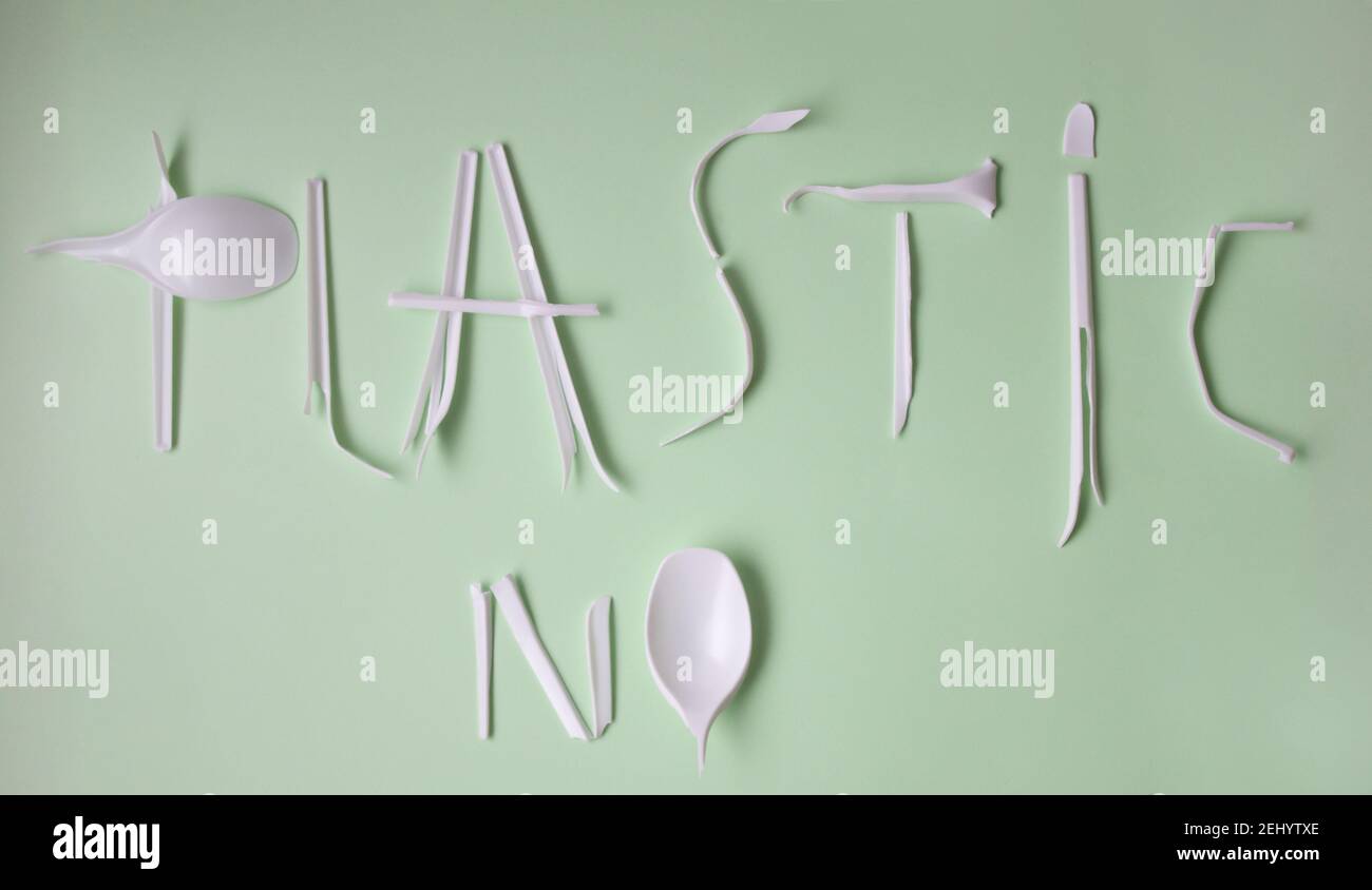 Lettering no plastic made of white broken plastic spoons on a green ...