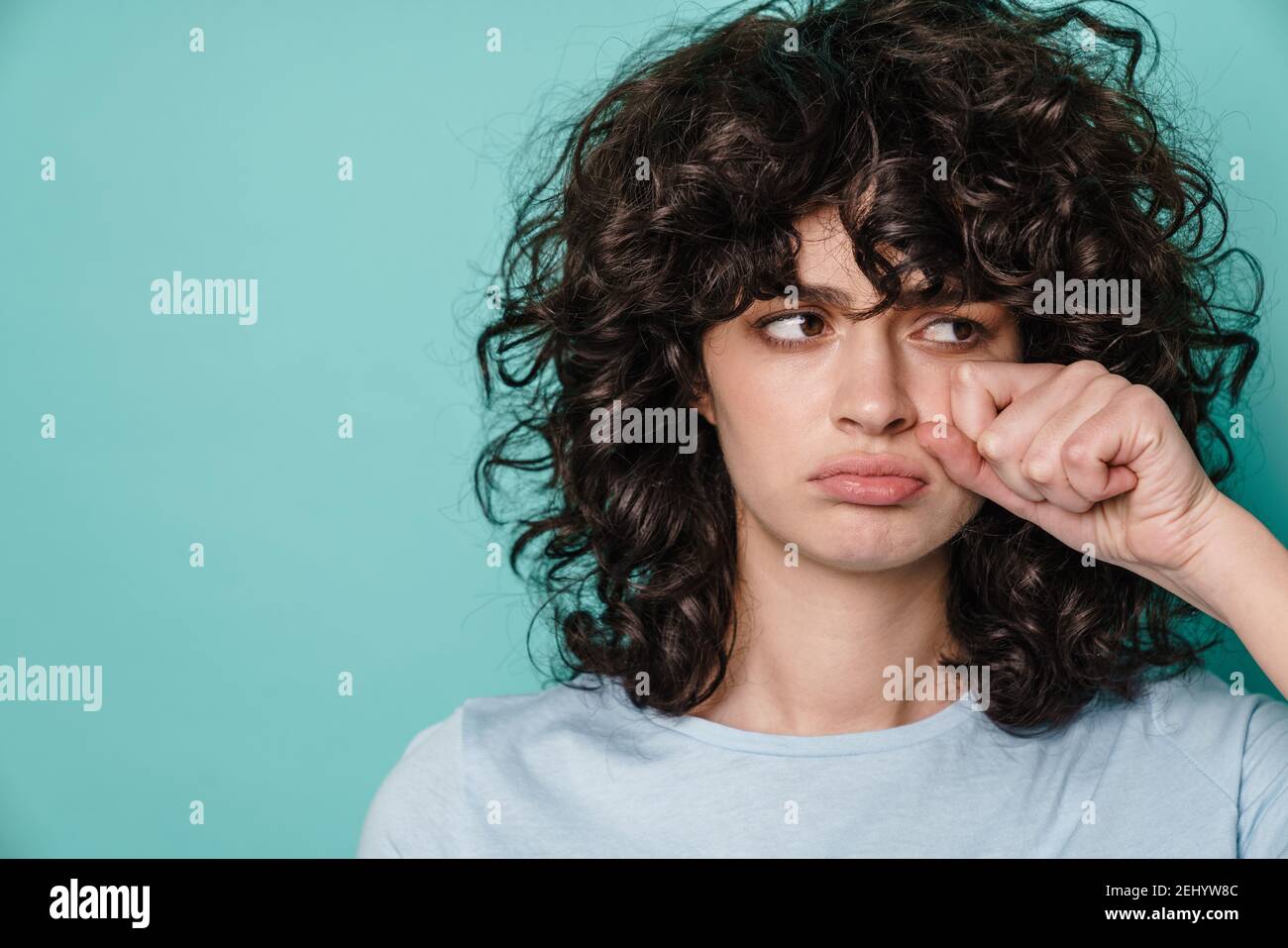 Caucasian unhappy curly girl posing and crying at camera isolated over ...
