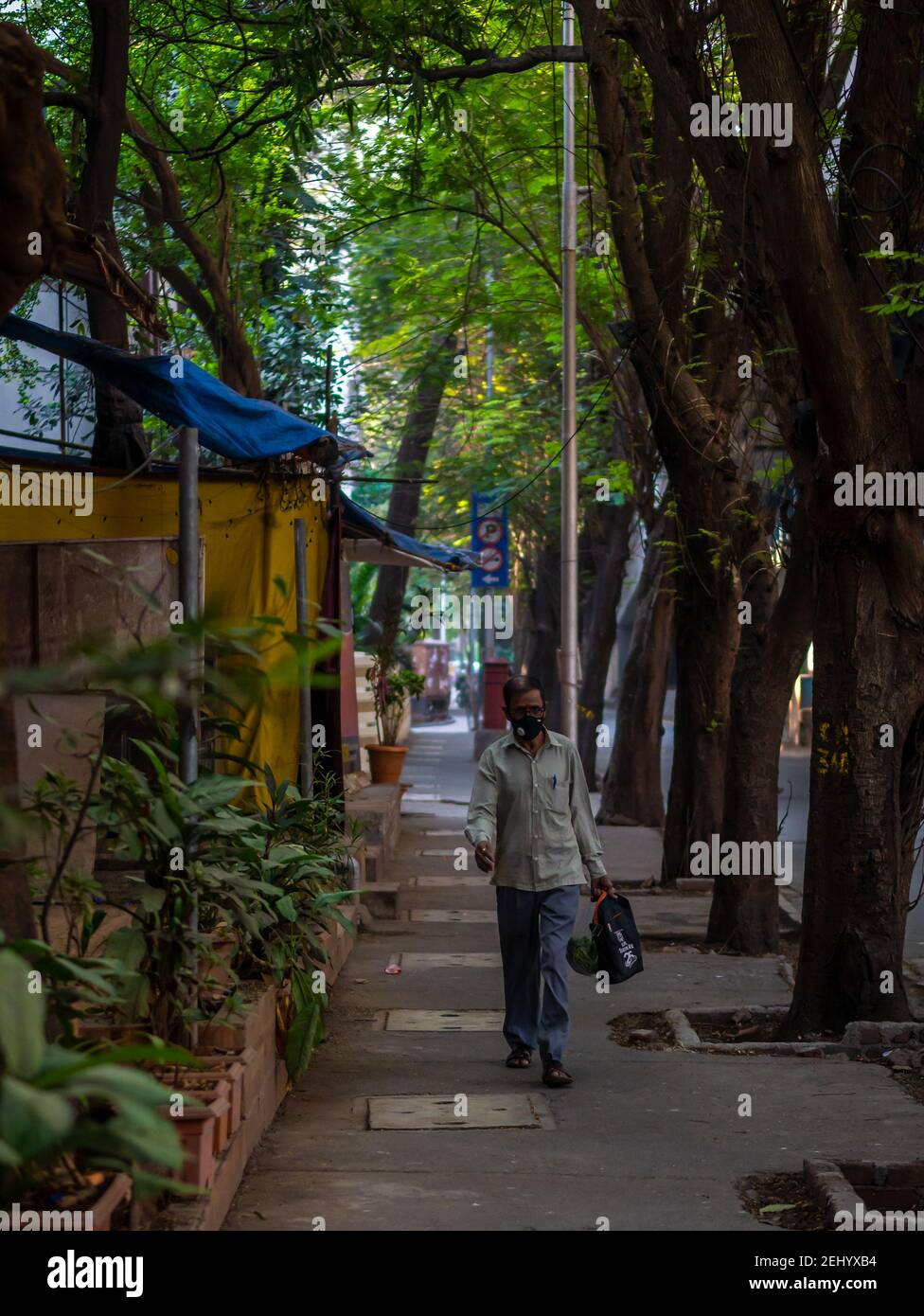 Thane, India, December 22,2020: Indian man walking on a footpath ...