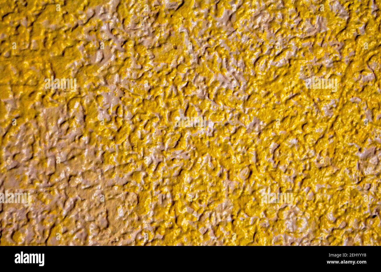 Abstract grainy texture on yellow and white wall. It can be used as a ...