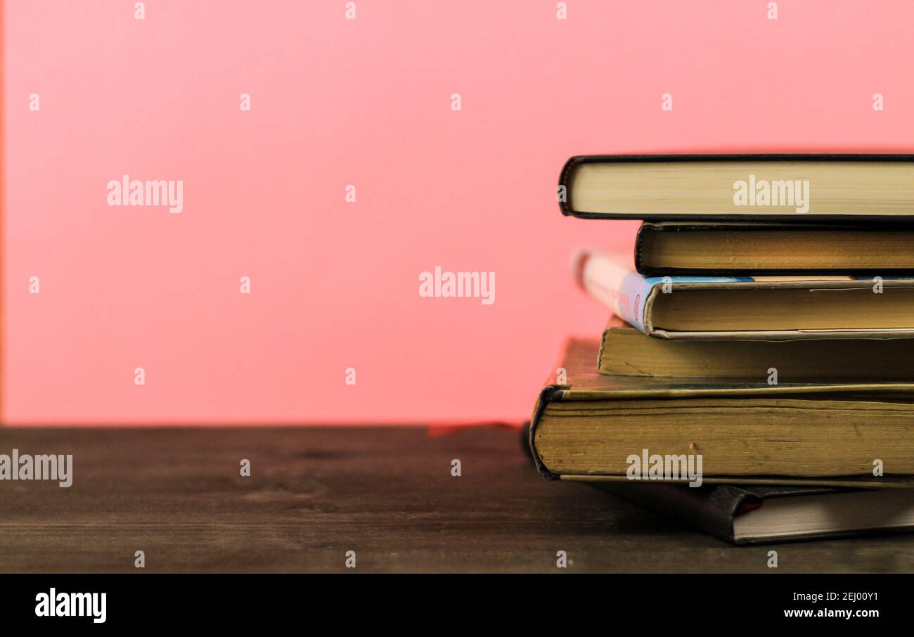 Old Stacked books on pink background Stock Photo - Alamy