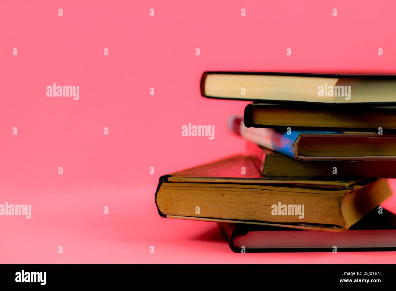 Old Stacked books on pink background Stock Photo - Alamy