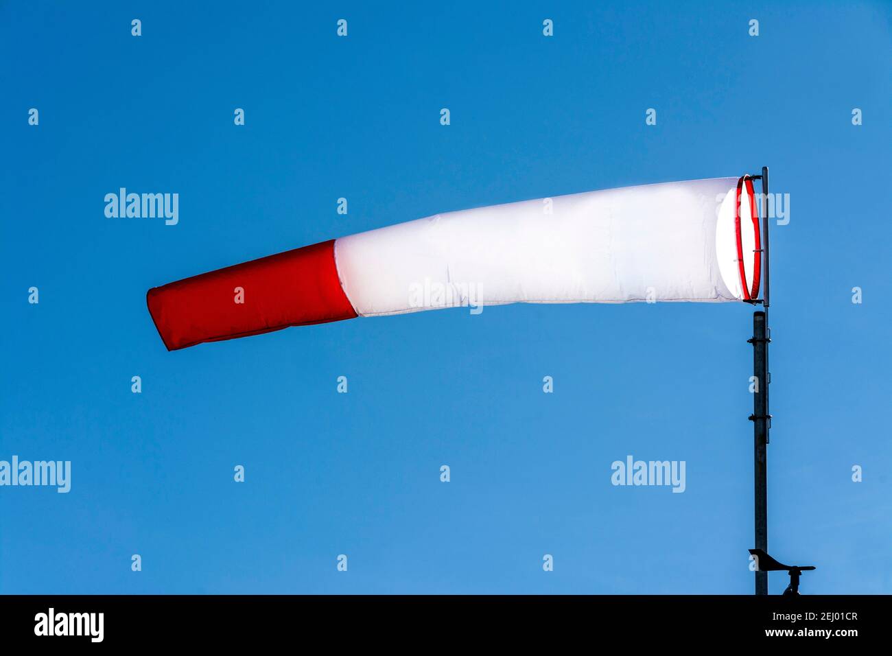 Wind sock indicating strong breezes against a clear blue sky at an ...