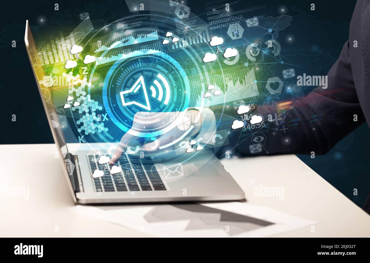 Business hand typing on a modern laptop with loud sound icon coming out ...