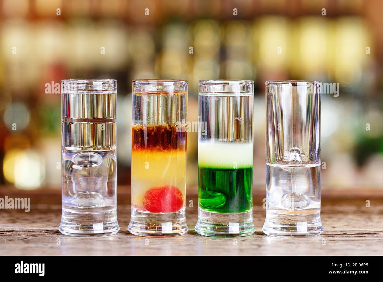 Cocktail set on the bar counter on a blurry background of a bottle with ...