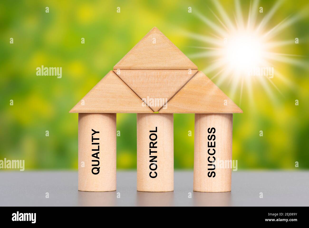 quality, control and success printed on three pillars Stock Photo - Alamy