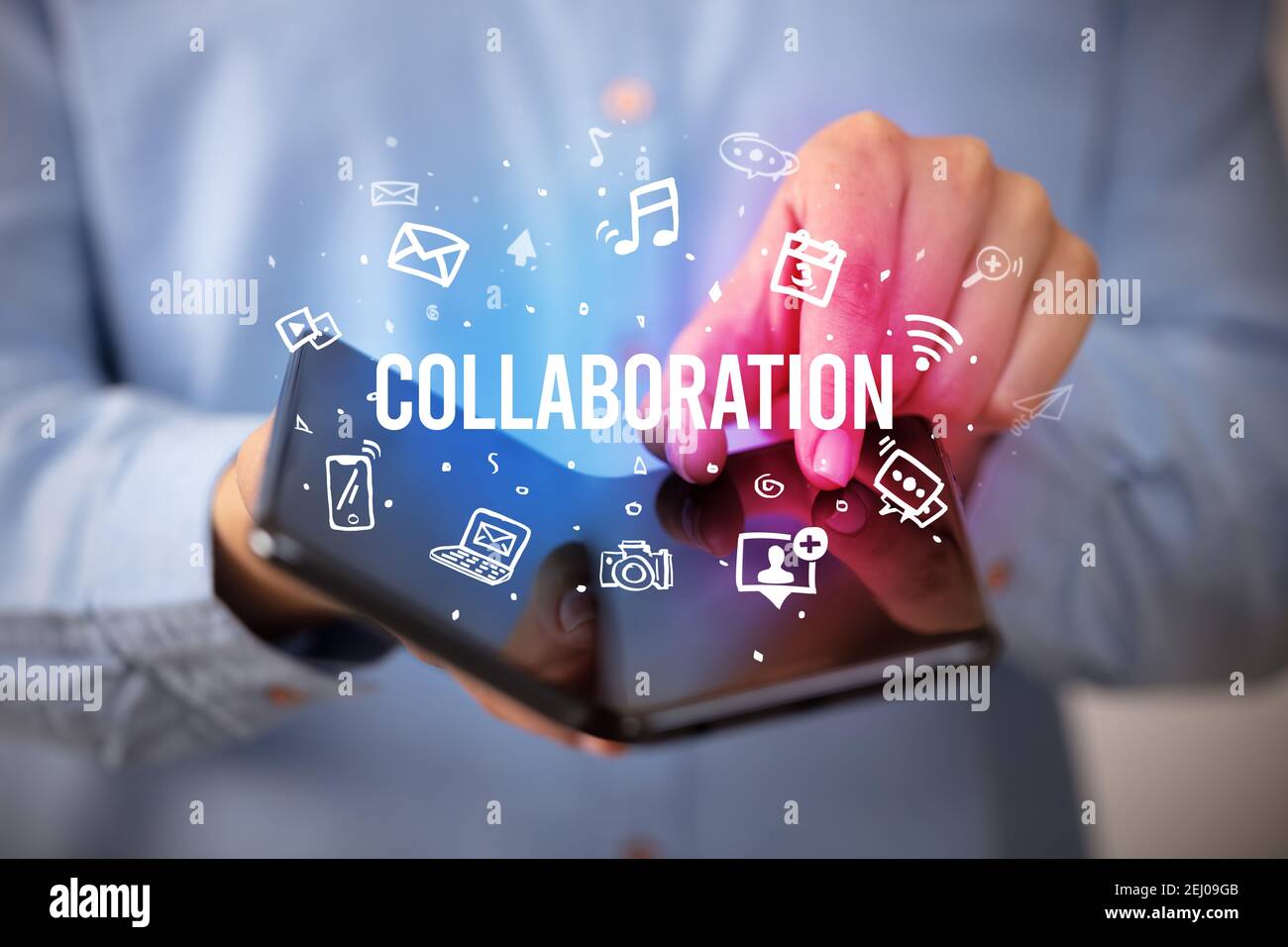 Businessman holding a foldable smartphone with COLLABORATION ...