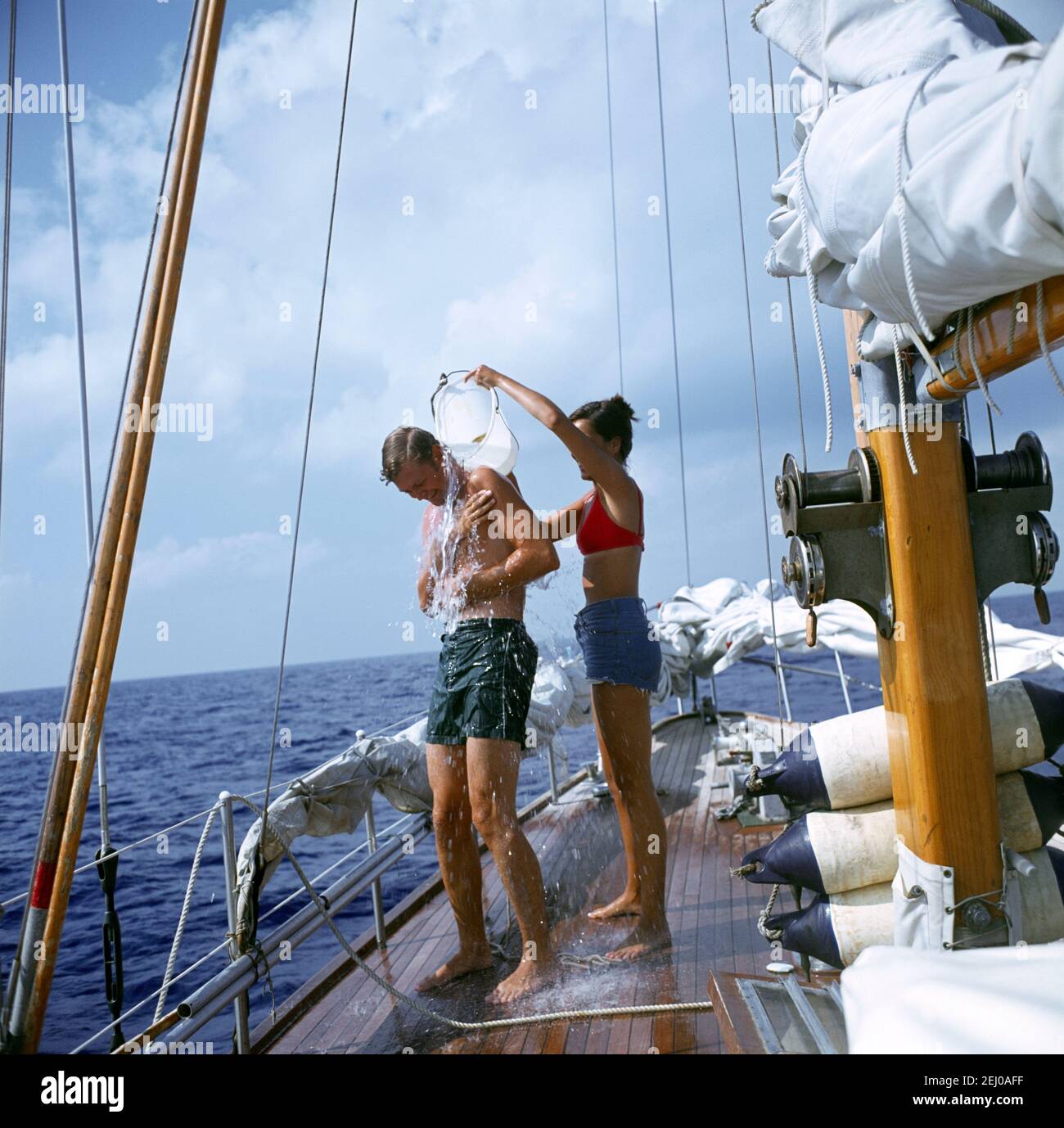 Couple Washing with Seawater from Bucket Onboard Sailing Boat Asperida ...