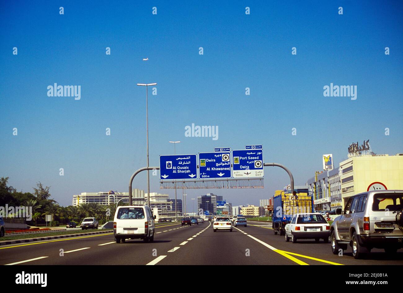 Dubai UAE Traffic on Road with Bilingual Road Sign Stock Photo - Alamy