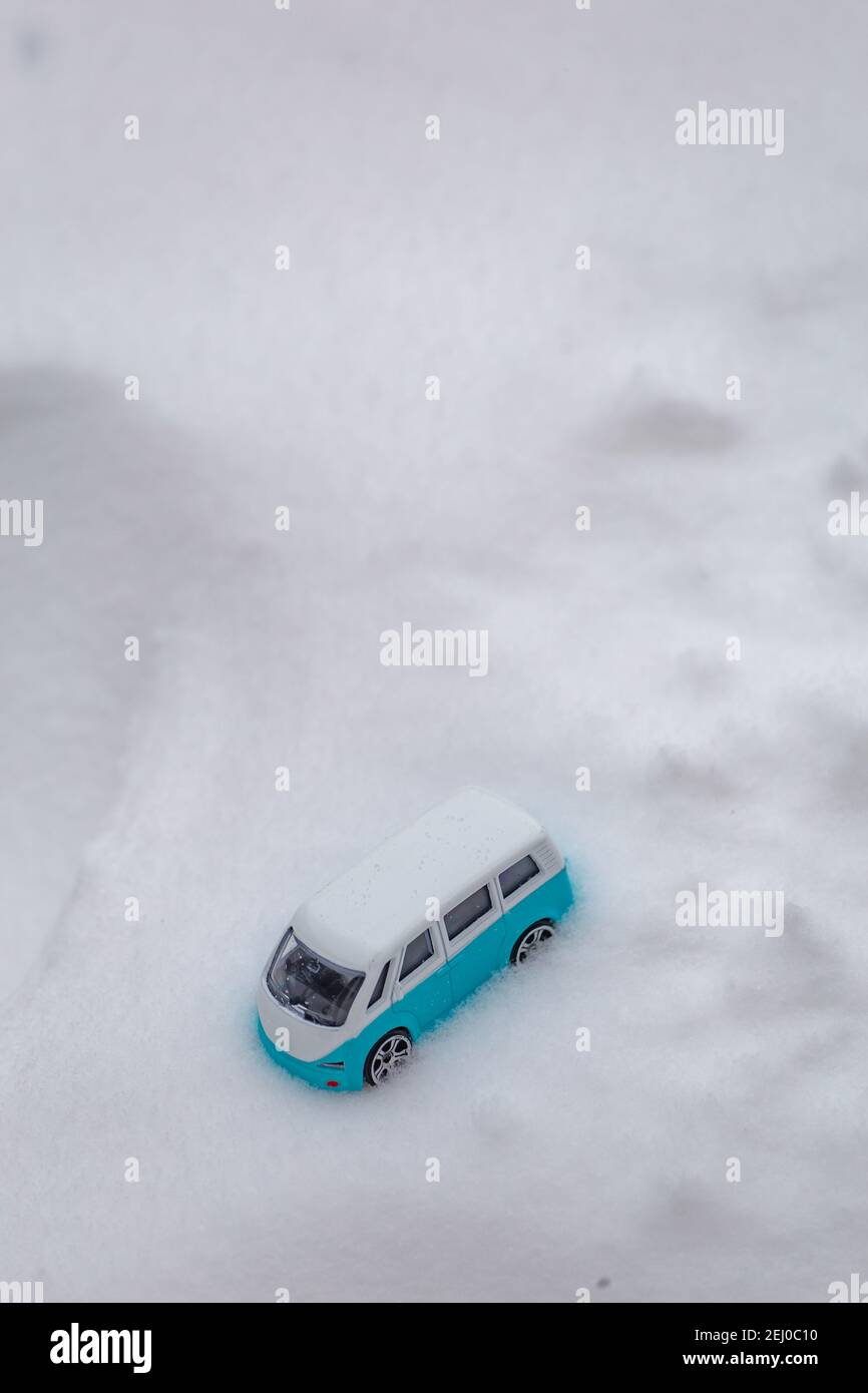 Light blue camper bus stuck in the snow Stock Photo - Alamy