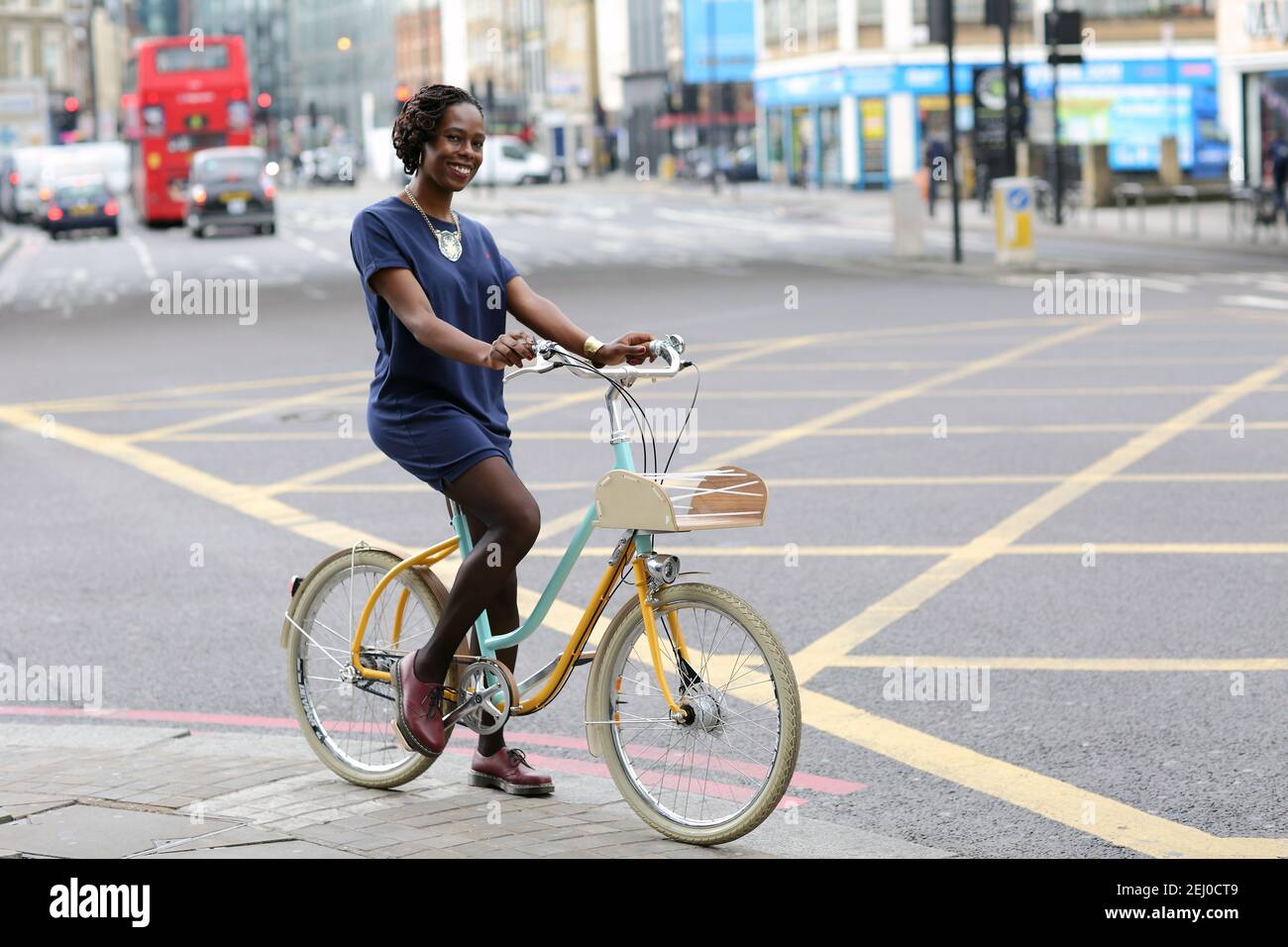 Girl sitting on bicycle with urban background in London , UK Stock ...