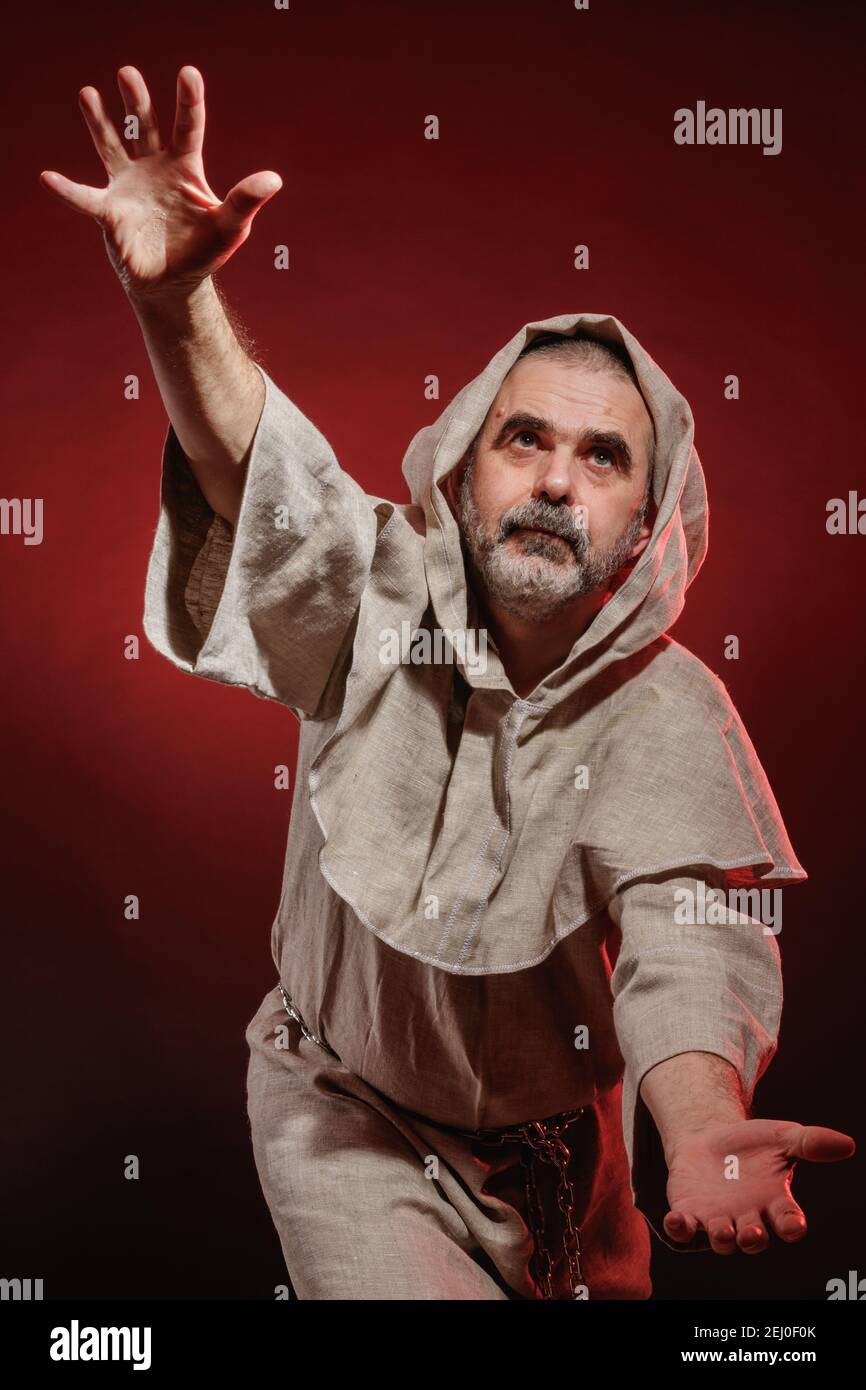 Mad monk with outstretched arms in pursuit of his faith Stock Photo - Alamy