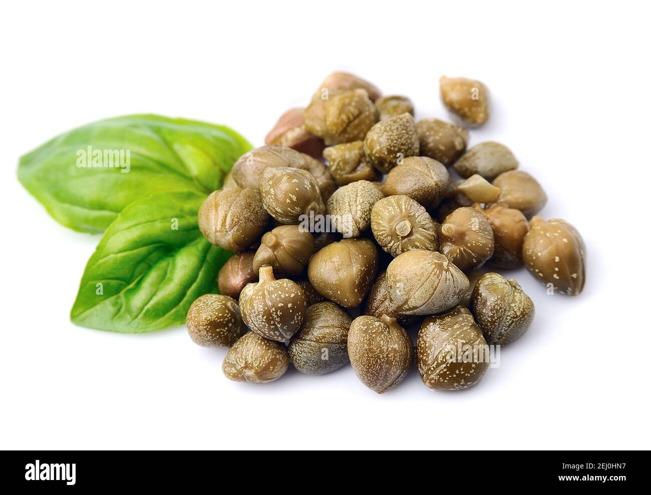 Capers vegetables with basil close up on white texture Stock Photo - Alamy