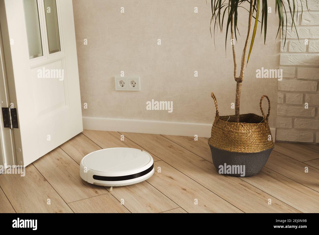 Robotic vacuum cleaner cleaning living room Stock Photo - Alamy