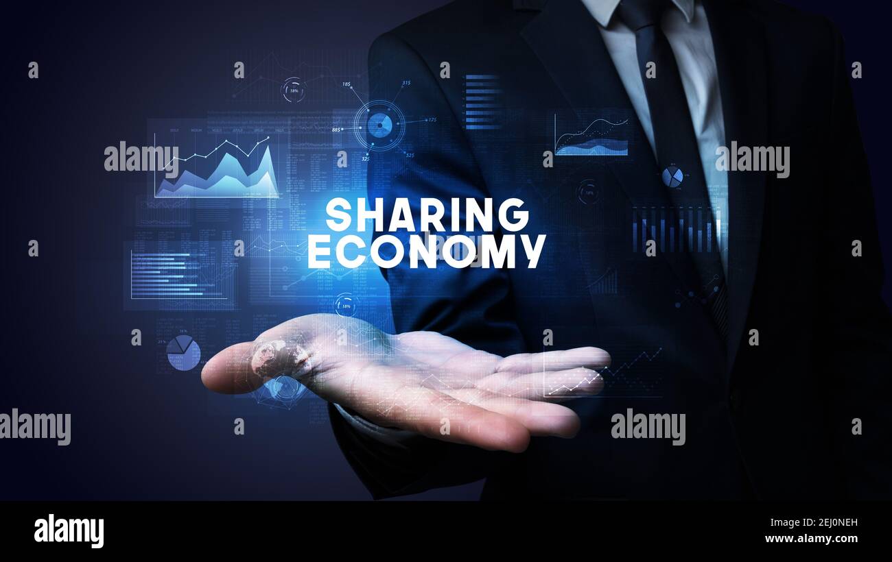 Hand of Businessman holding SHARING ECONOMY inscription, business ...