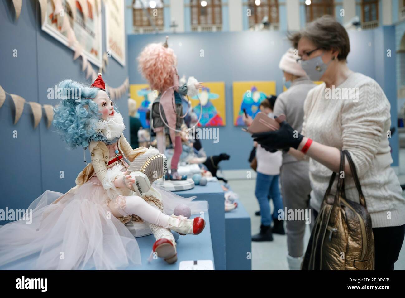 Moscow, Russia. 20th Feb, 2021. A visitor wearing a face mask looks at ...