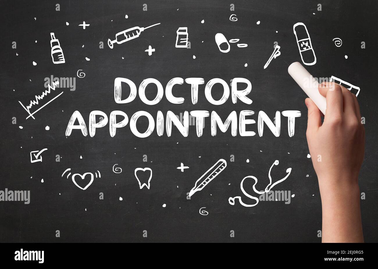 Hand drawing DOCTOR APPOINTMENT inscription with white chalk on ...
