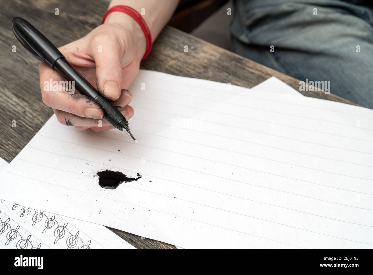 Calligraphy training. Fountain pen in ink-stained hands Stock Photo - Alamy