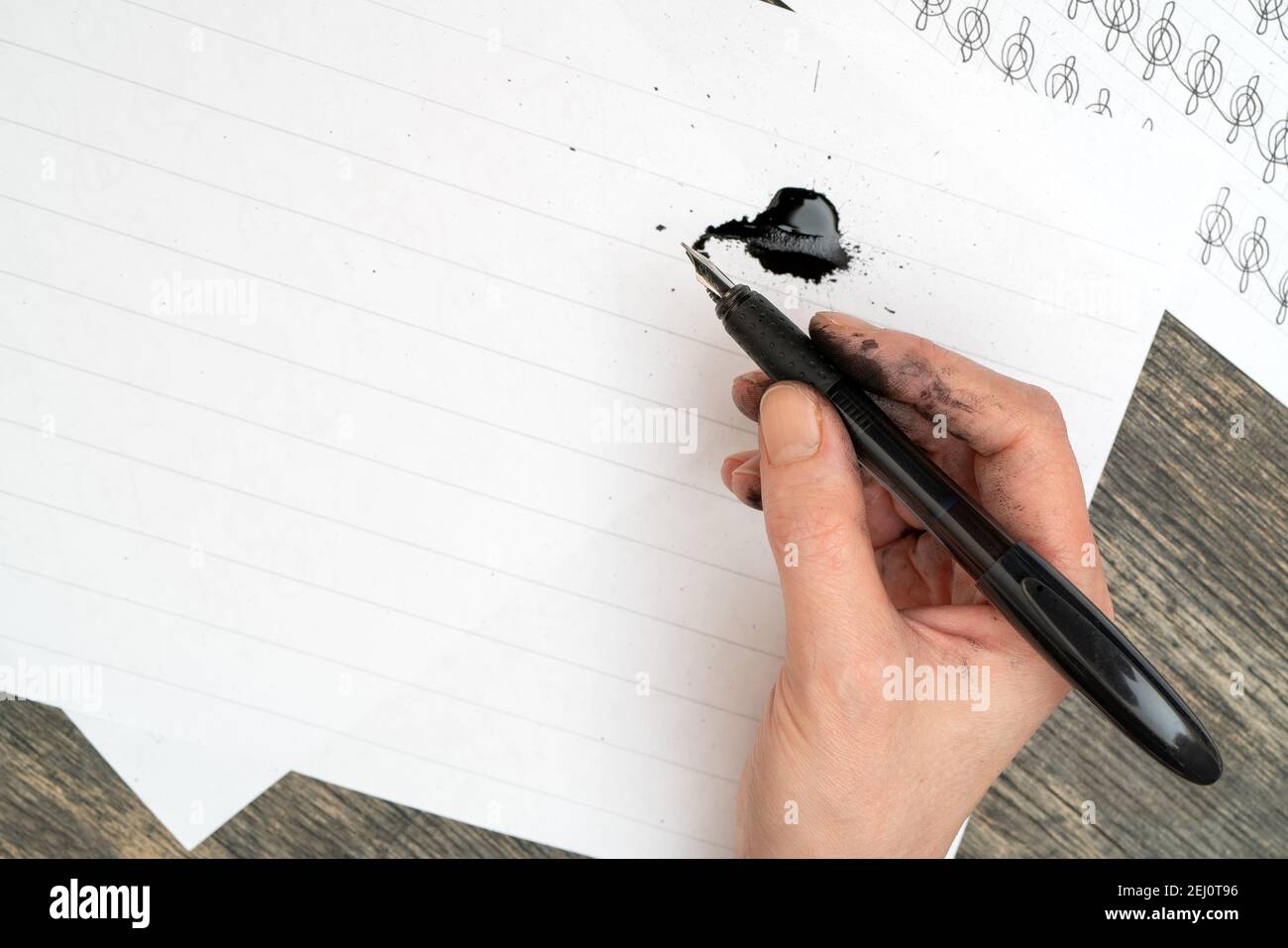 Calligraphy training. Fountain pen in ink-stained hands Stock Photo - Alamy