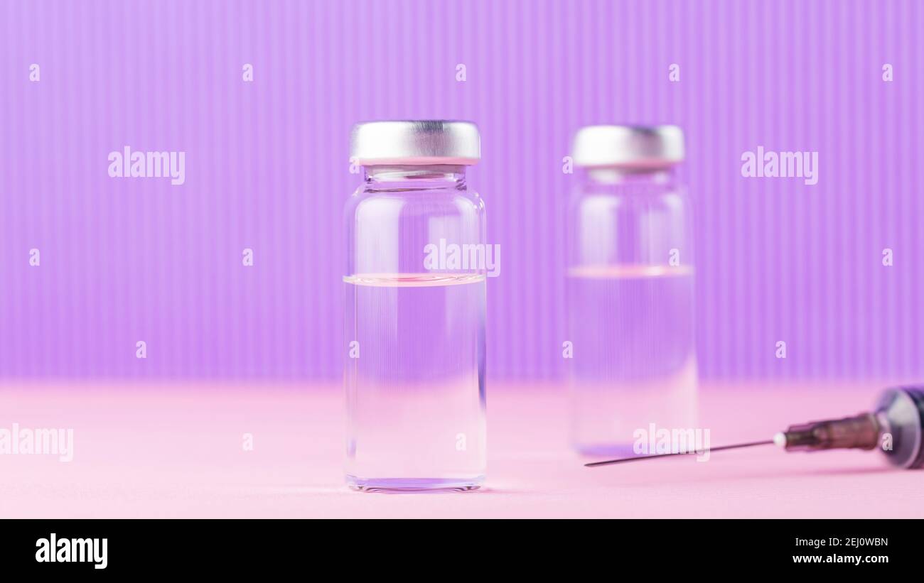 Vaccines and syringe on a pink purple background for prevention and ...