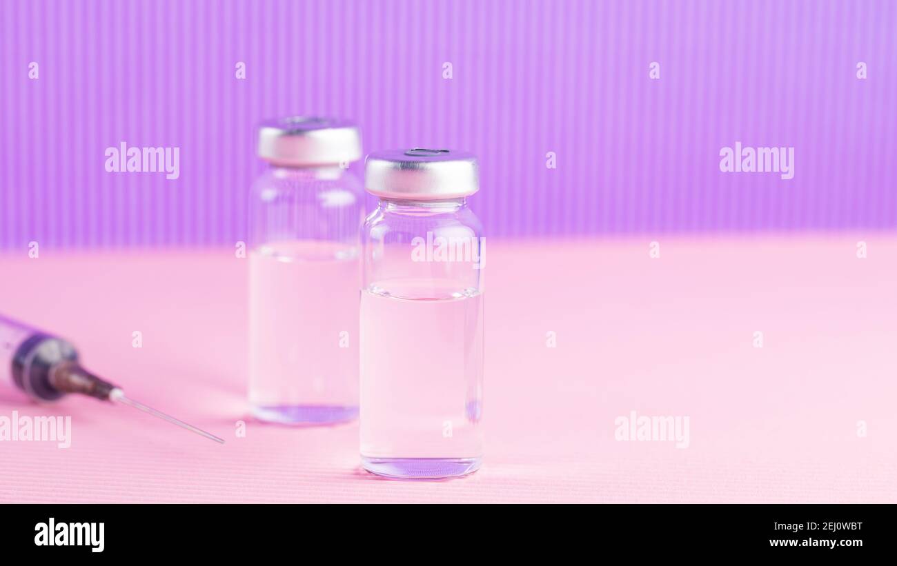 Vaccines and syringe on a pink purple background for prevention and ...