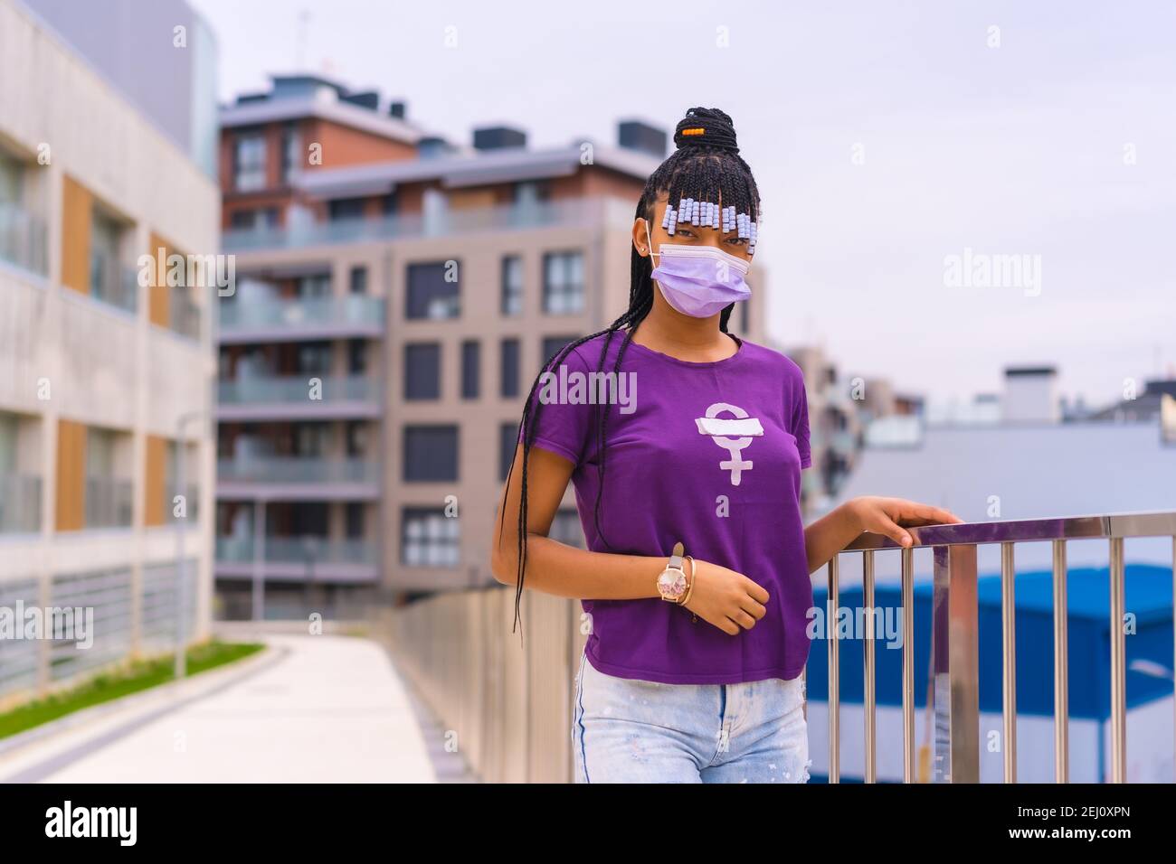 Attractive Native American female walking in the city wearing a mask ...