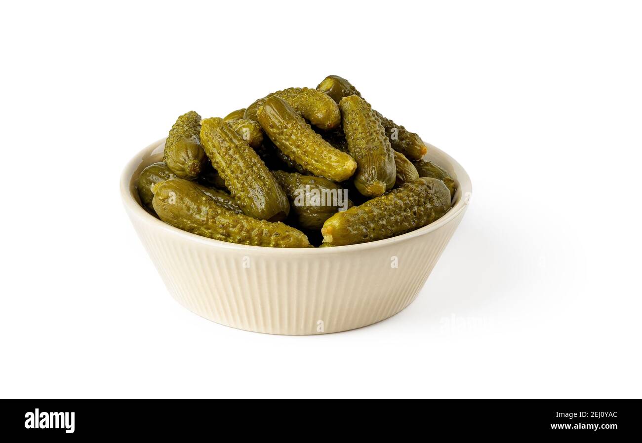 Pickled gherkins in a beige ceramic bowl isolated on a white background ...