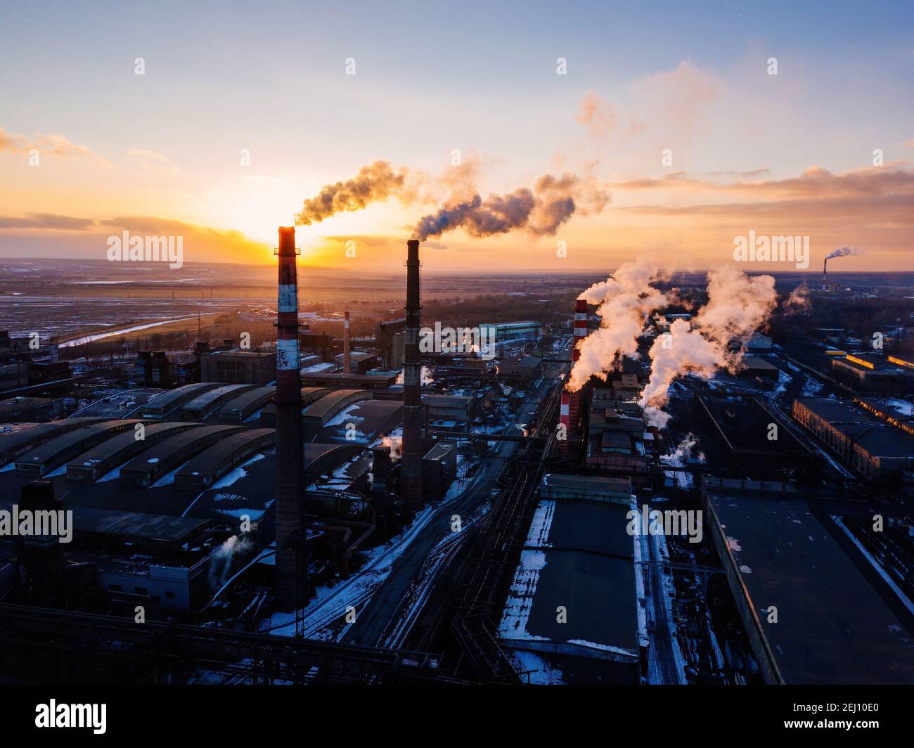 Industrial landscape at the sunset, aerial view. Smoke coming out from ...