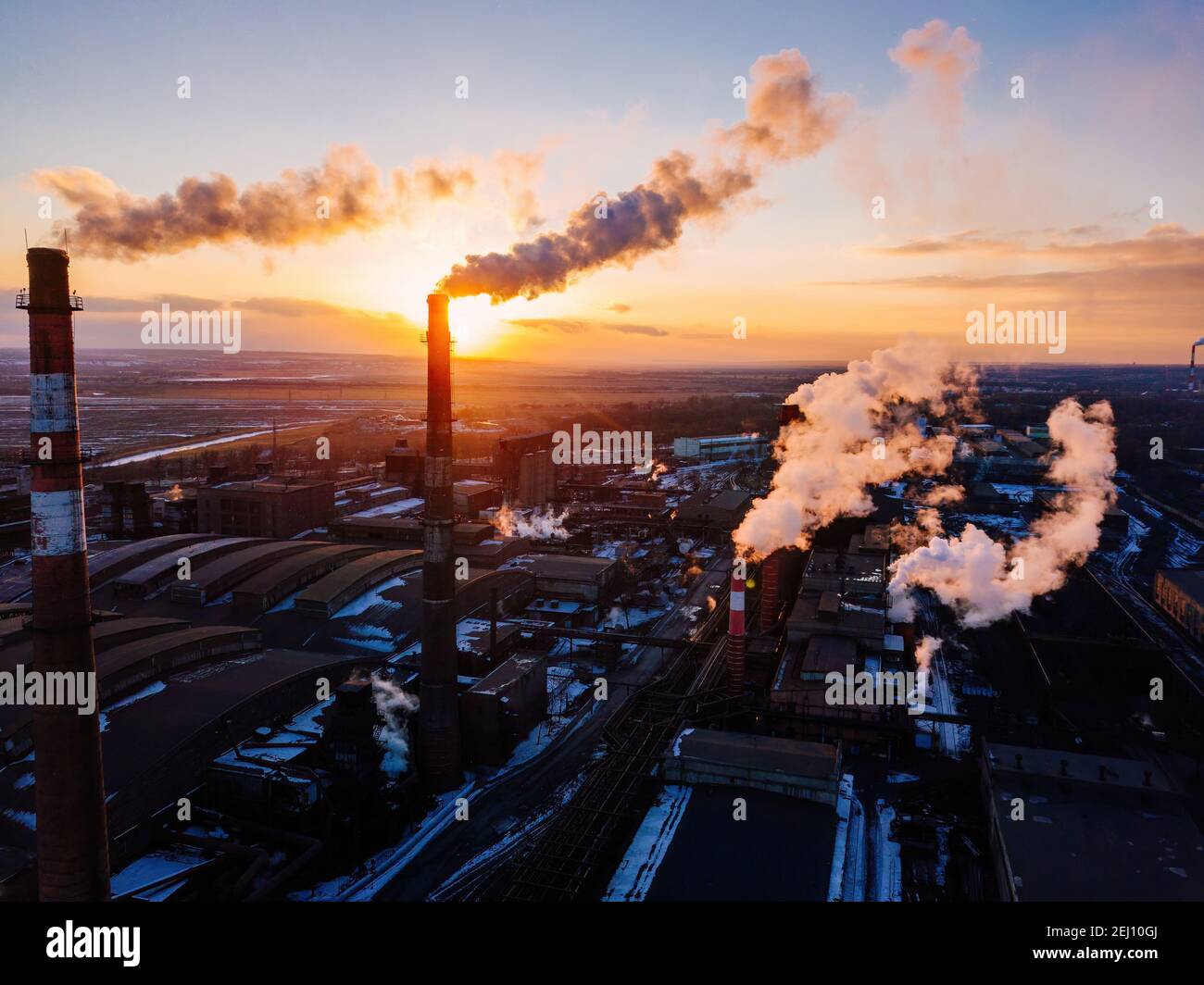 Industrial landscape at the sunset, aerial view. Smoke coming out from ...