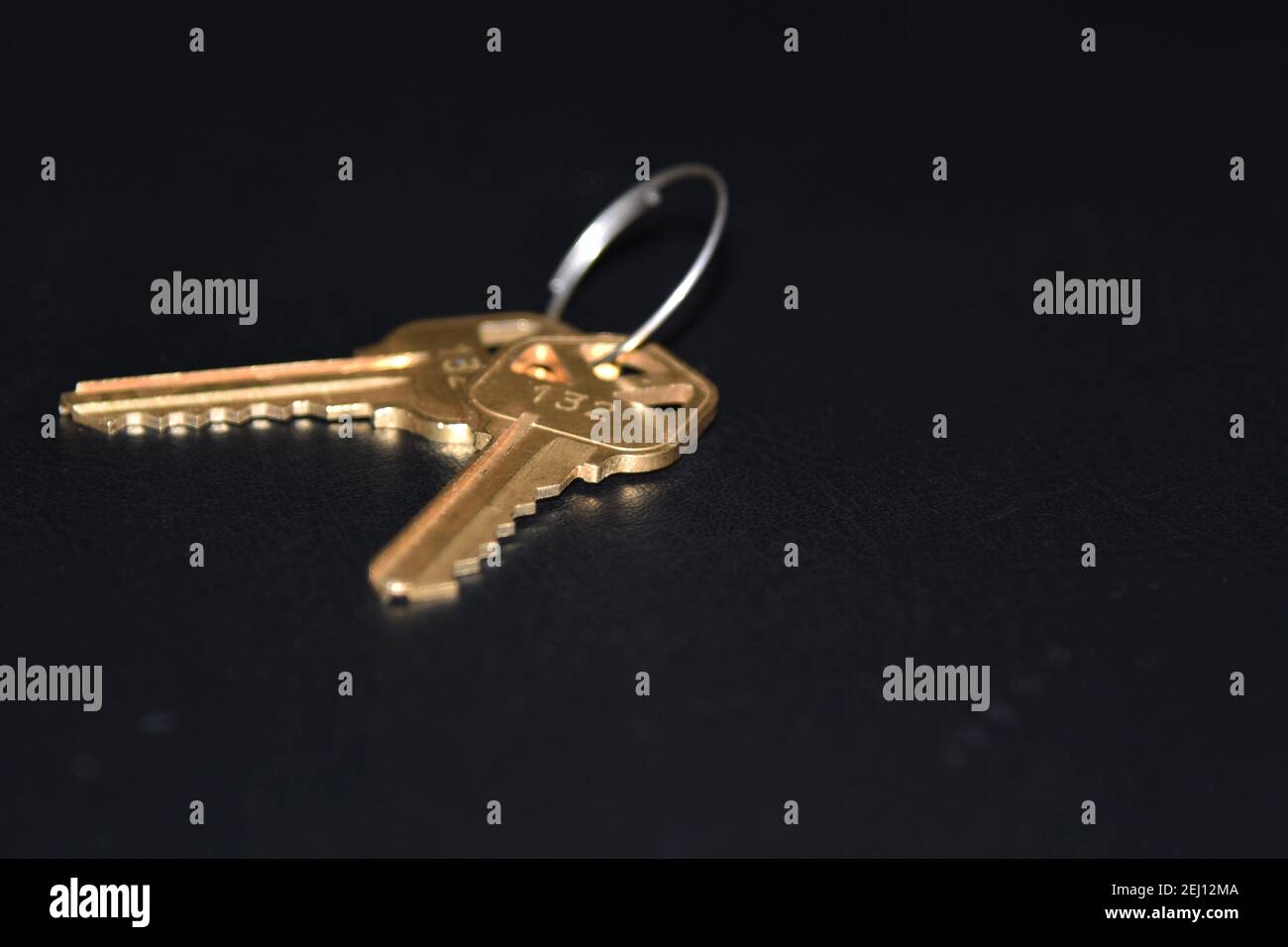 Brass keys on a black background concept for new home or security Stock ...