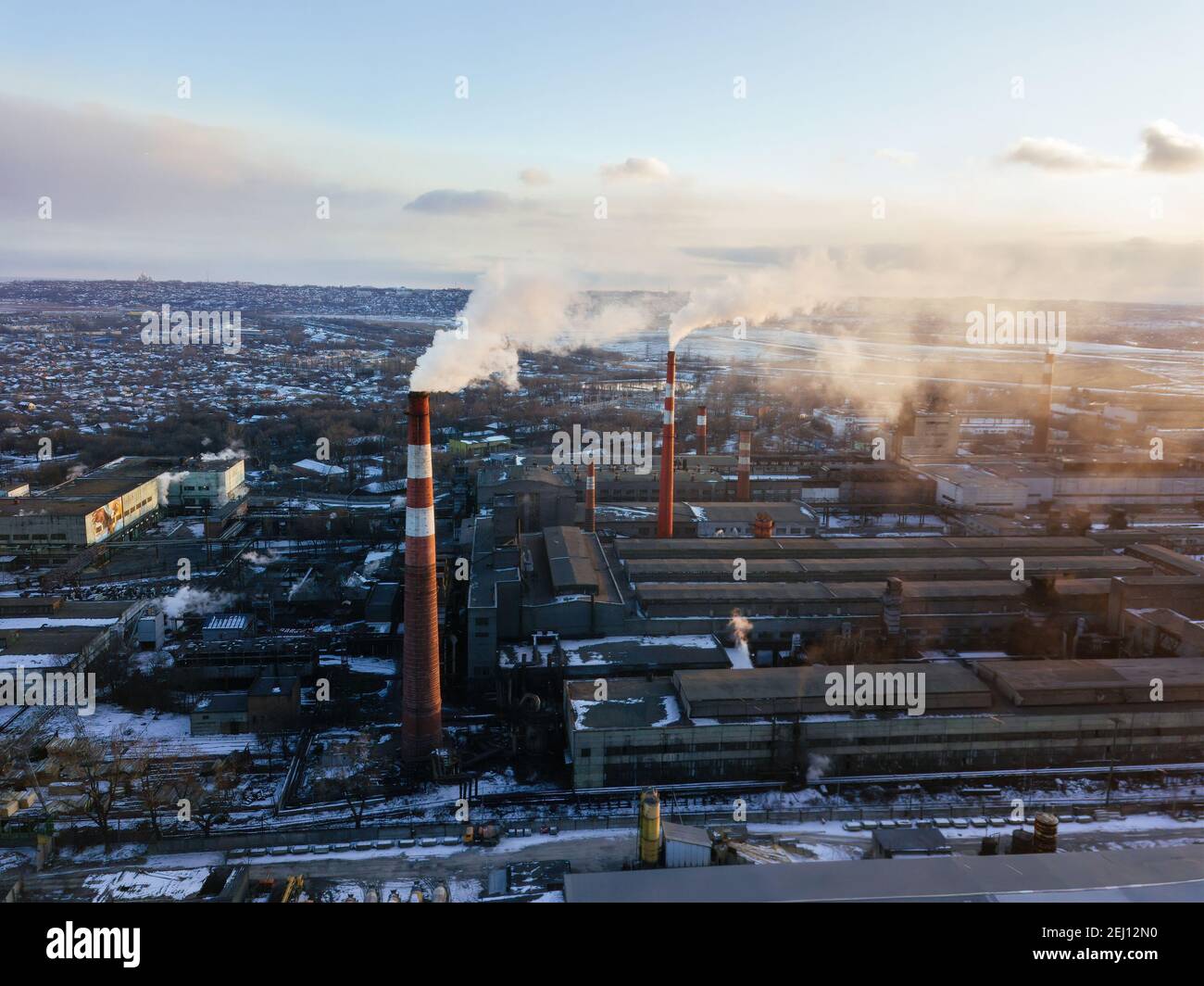 Industrial landscape at the sunset, aerial view. Smoke coming out from ...