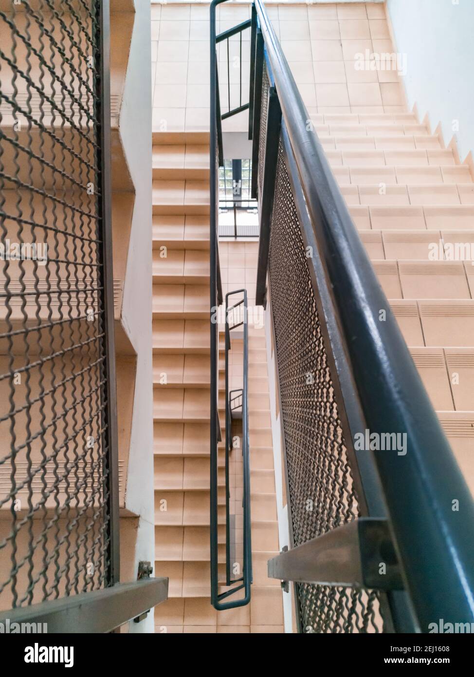 Top down view to modern staircase with light stairs and metal railings ...