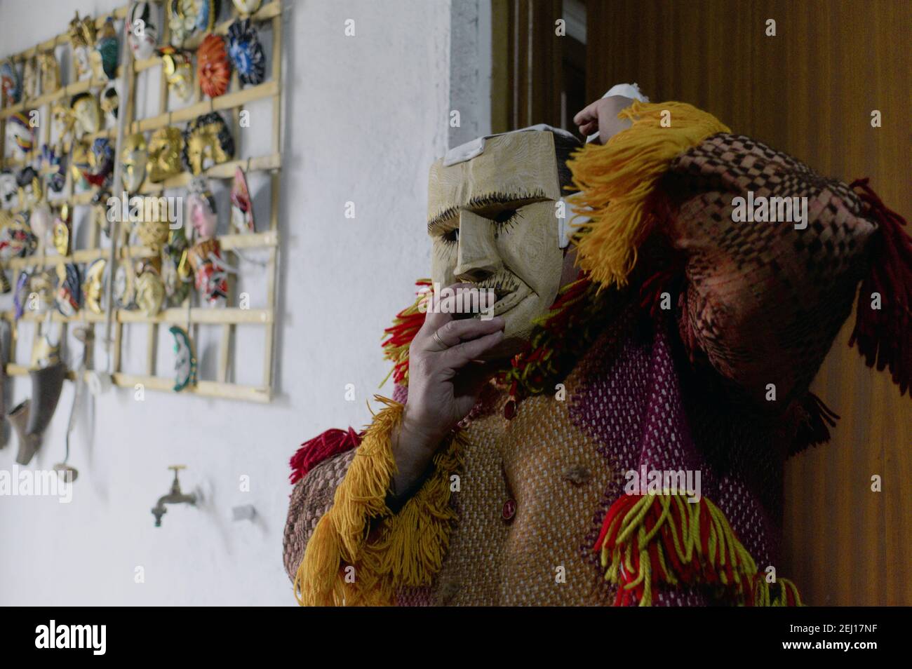 Mask builder in his workshop, carving traditional masks used in the ...