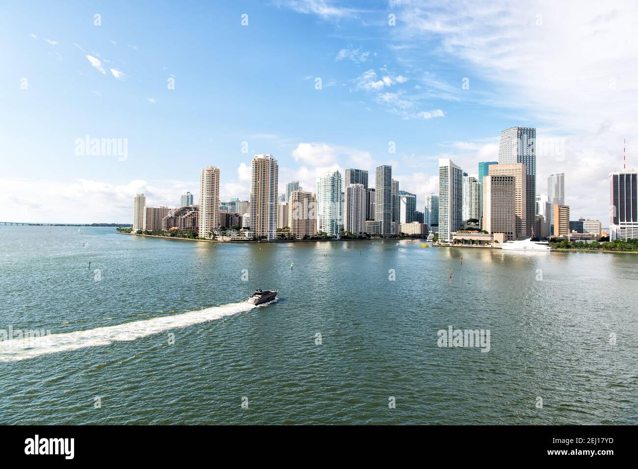 Aerial view of Miami skyscrapers with blue cloudy sky,white boat ...