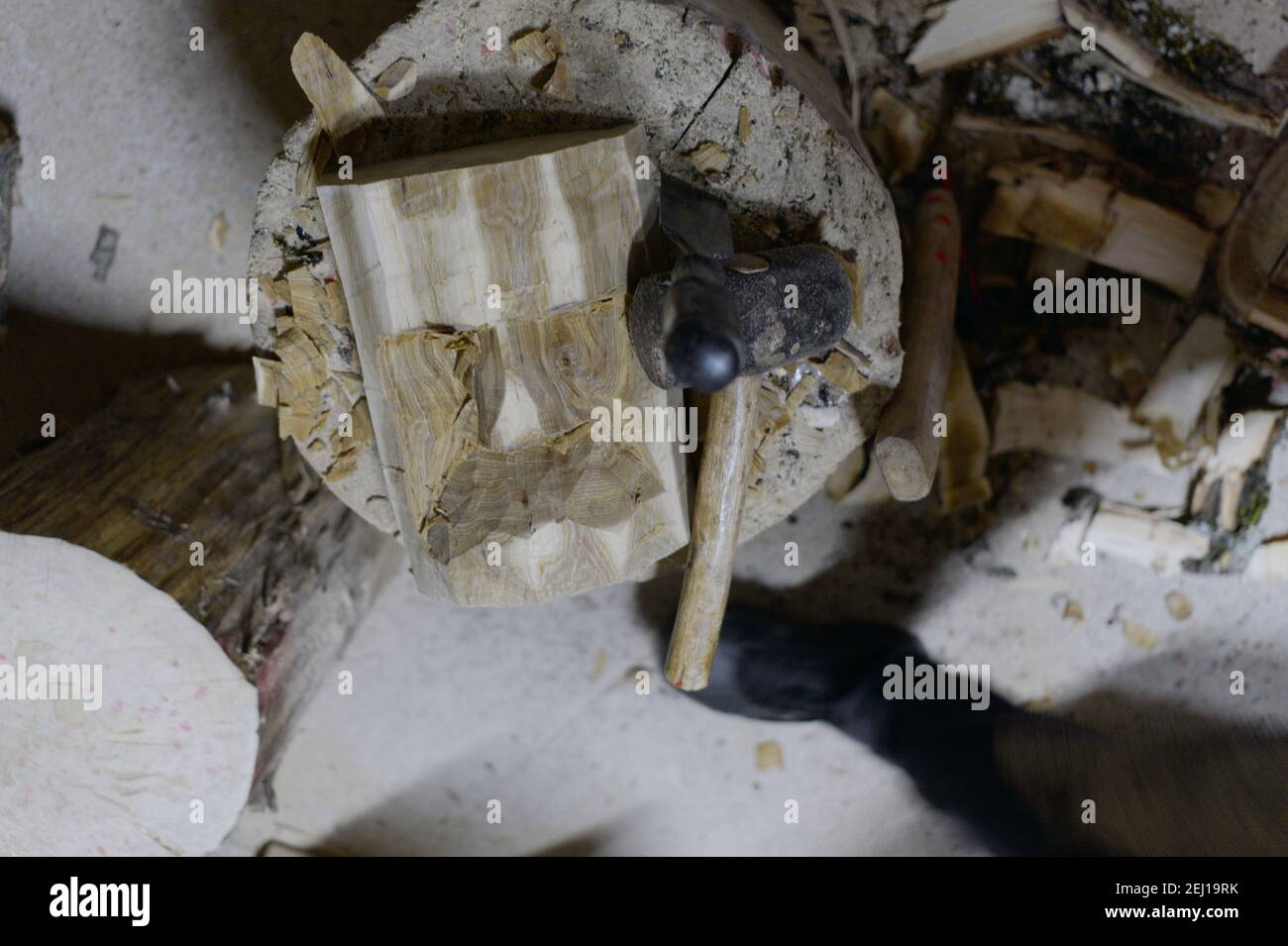 Mask builder in his workshop, carving traditional masks used in the ...
