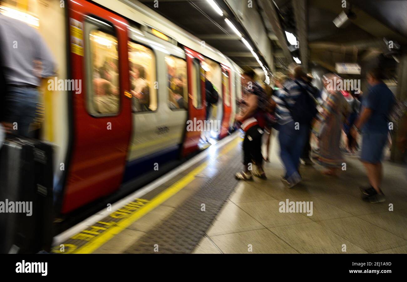 Random people at the underground tube station with Moving train motion ...