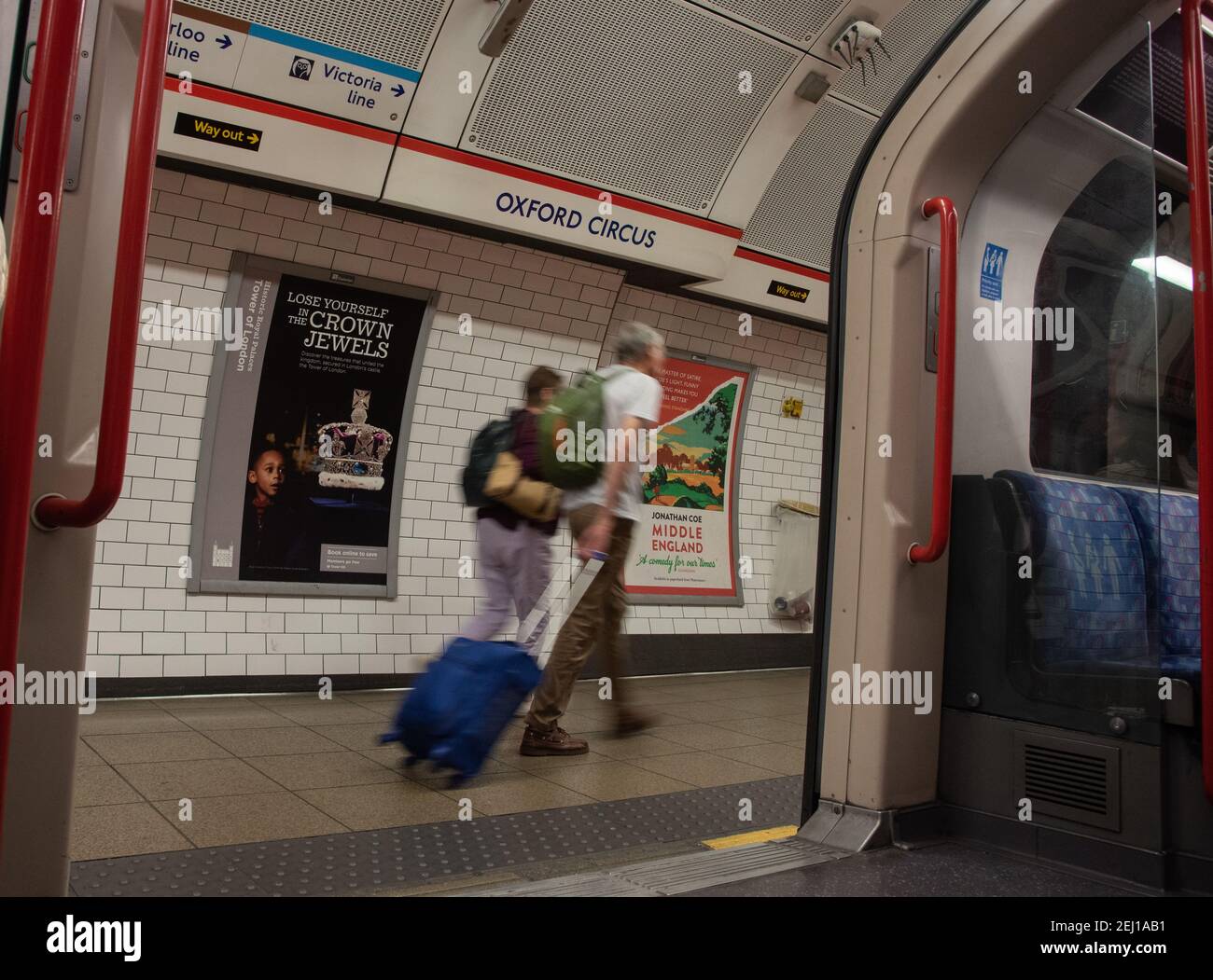 Random people at the underground tube station with Moving train motion ...