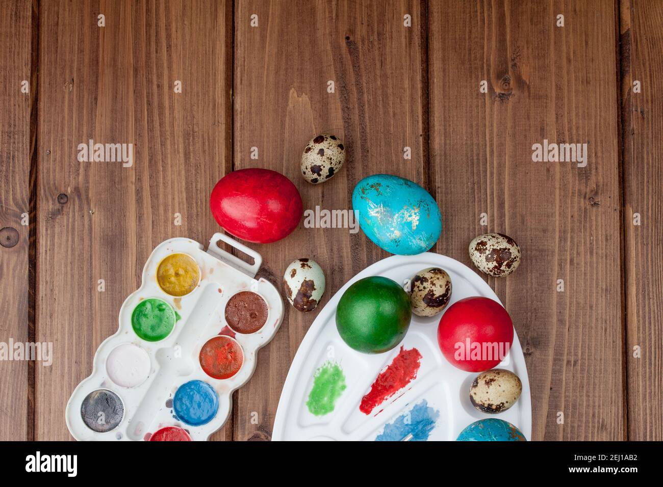 Colored eggs and paint on a wooden table, Easter background Stock Photo ...