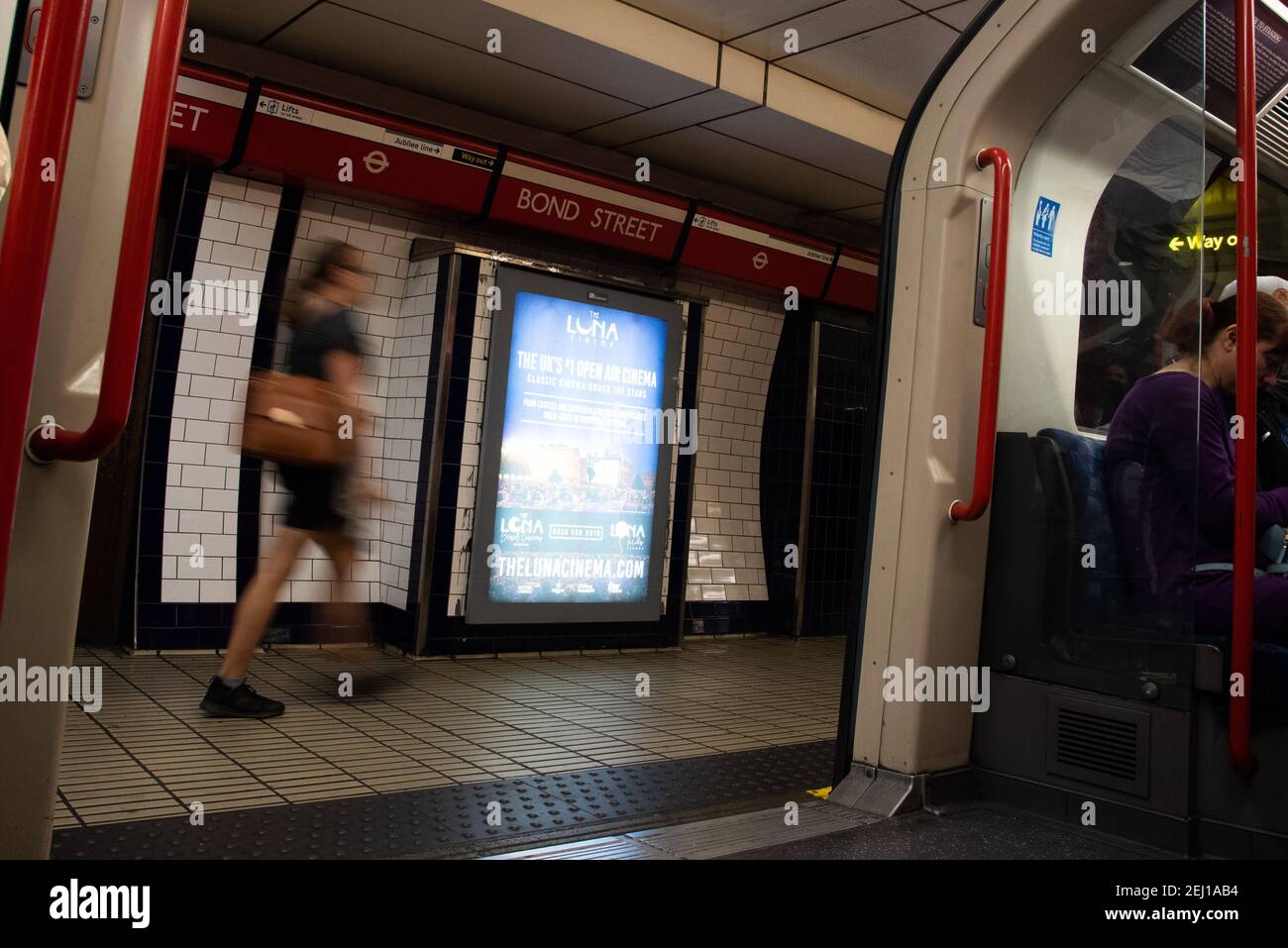 Random people at the underground tube station with Moving train motion ...
