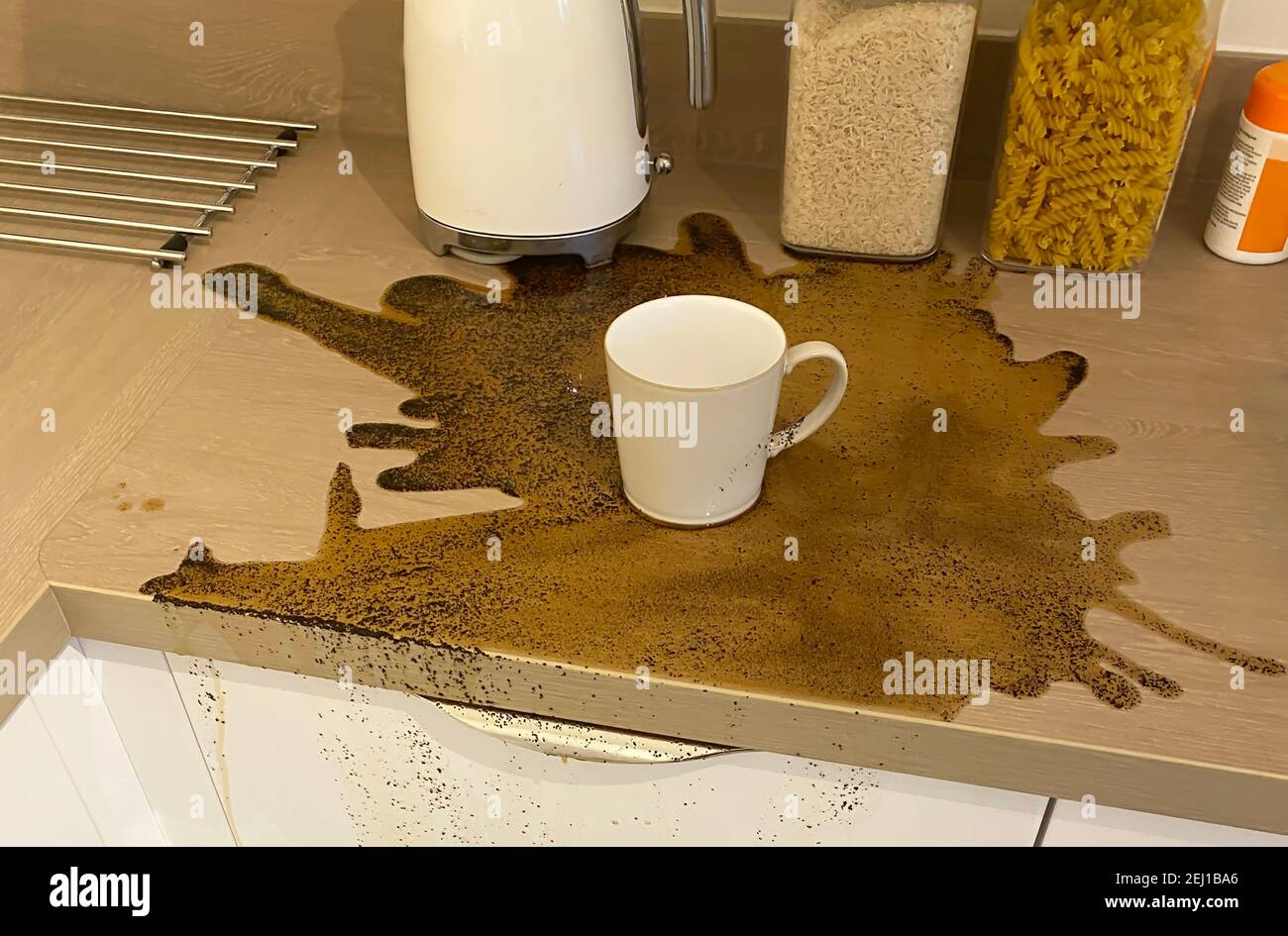 Spilt coffee drink and ground beans on kitchen worktop Stock Photo - Alamy