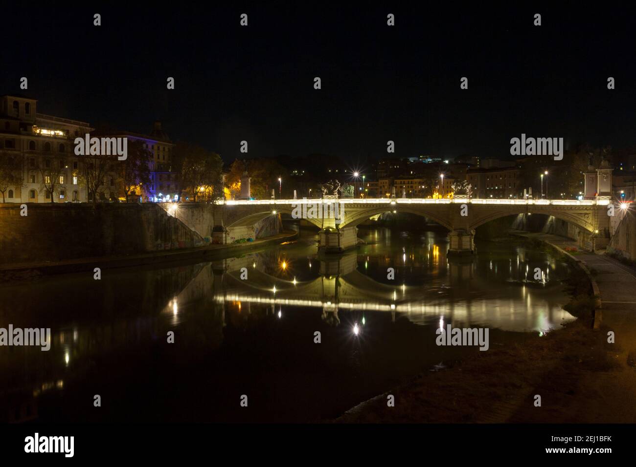 Night scene of Rome, Tevere river with city in background. Italian ...