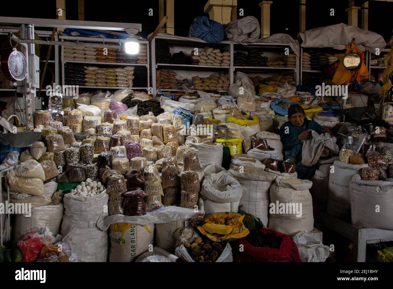 Market stall with grains run by elderly woman, Cusco, Peru Stock Photo ...