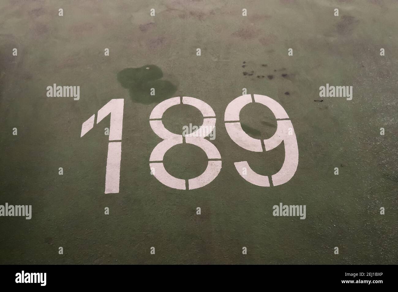 Numbers painted on concrete and asphalt textured surfaces Stock Photo ...