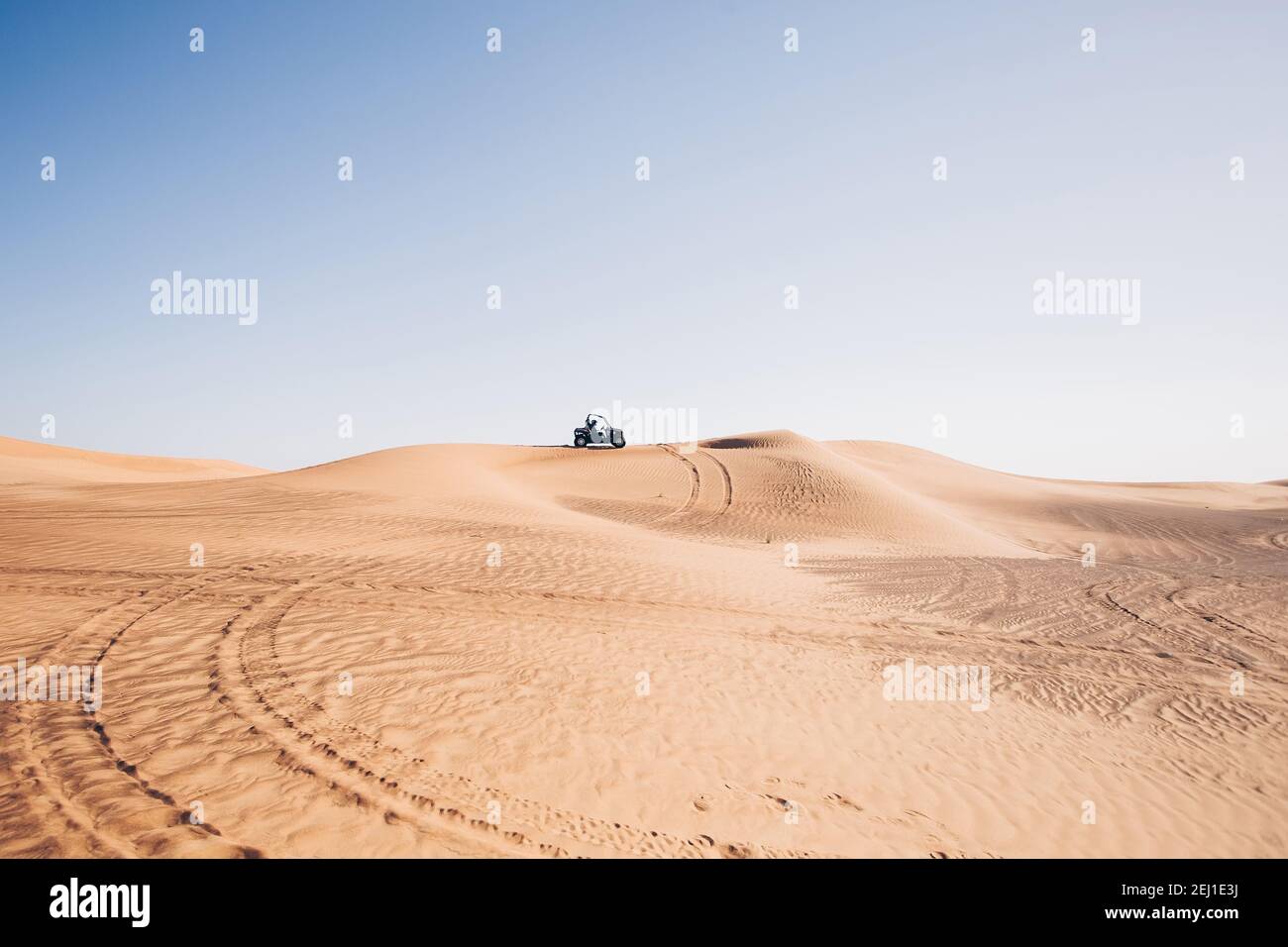Beautiful desert landscape with wheel traces and black buggy quad bike ...
