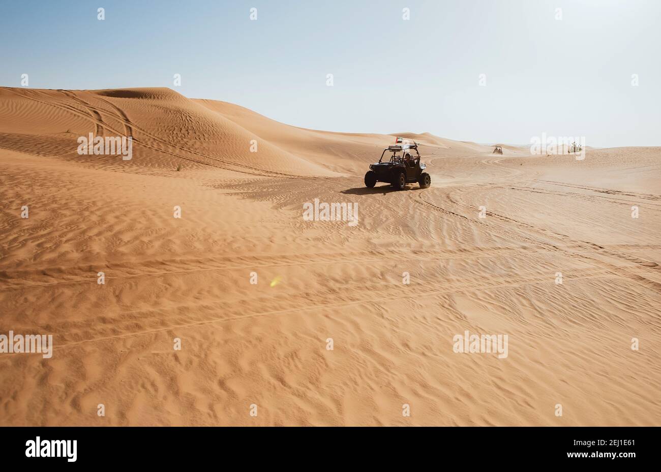 Al awir (Aweer) desert sand dunes with wheels traces and riding buggy ...