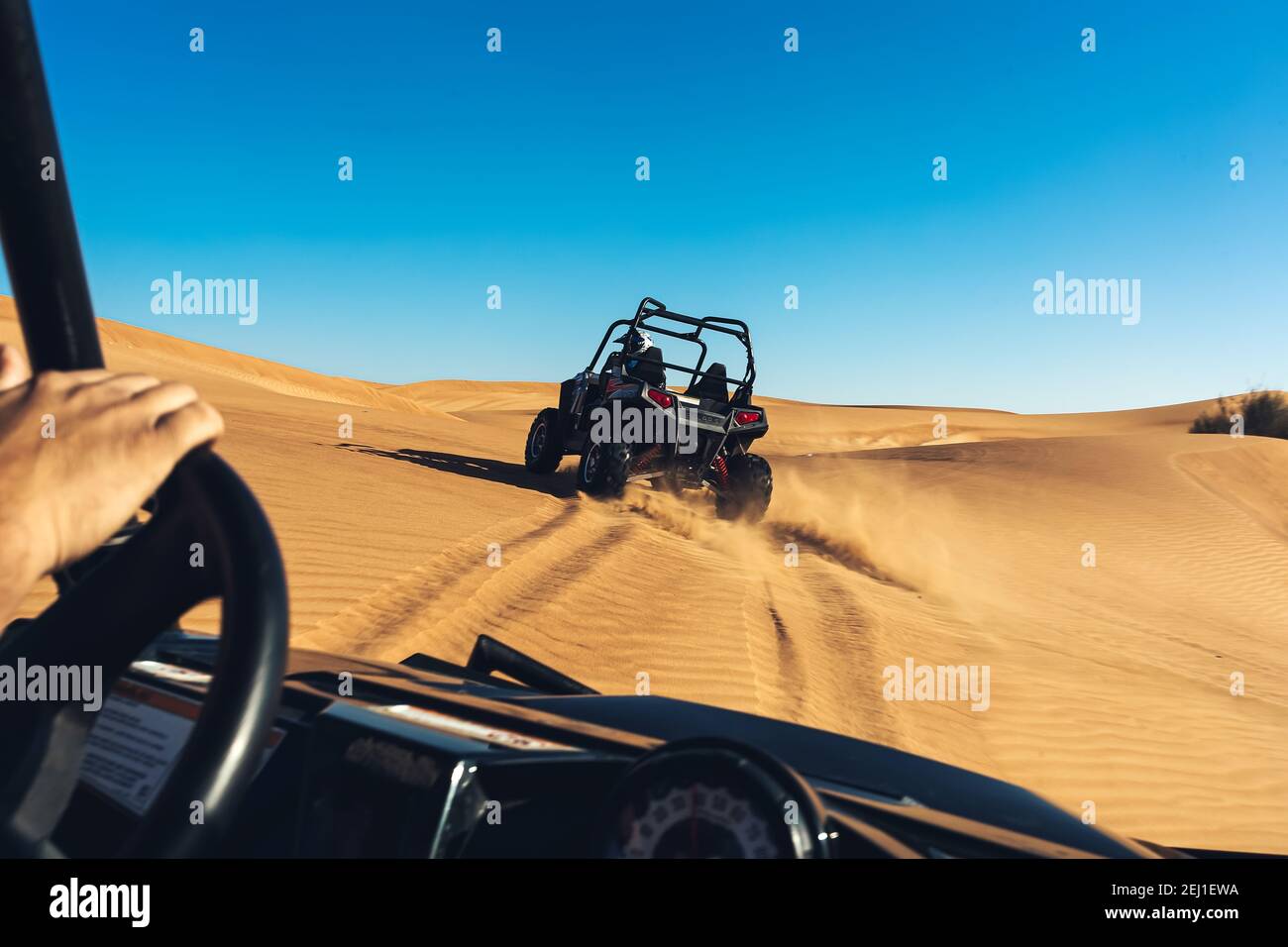 View of steering wheel and desert landscape from driver seat during ...