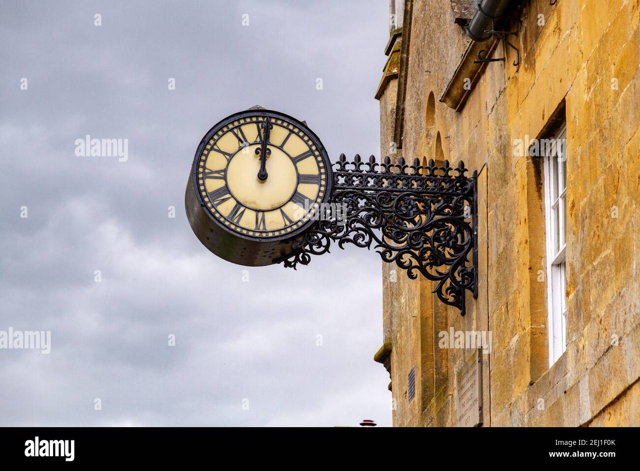 Old clock on a stone wall Stock Photo - Alamy